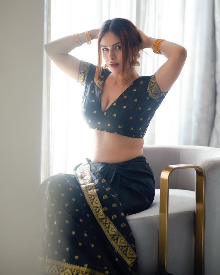 Neha Malik Shines In Black Saree With Golden Glow And Playful Charm - Filmibeat
